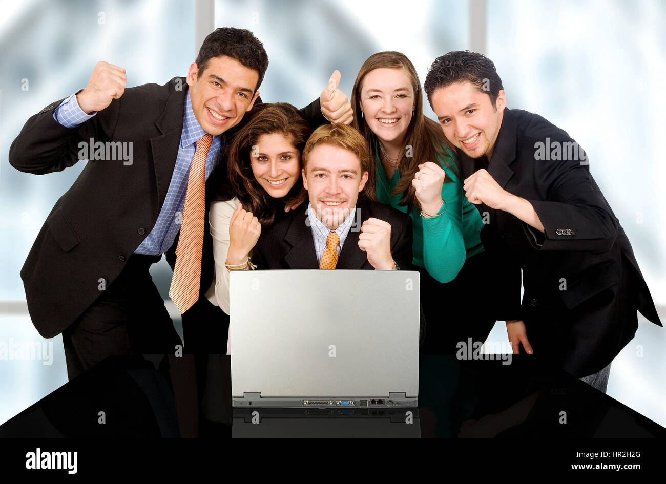 Business success team in an office in front of a laptop computer Stock ...