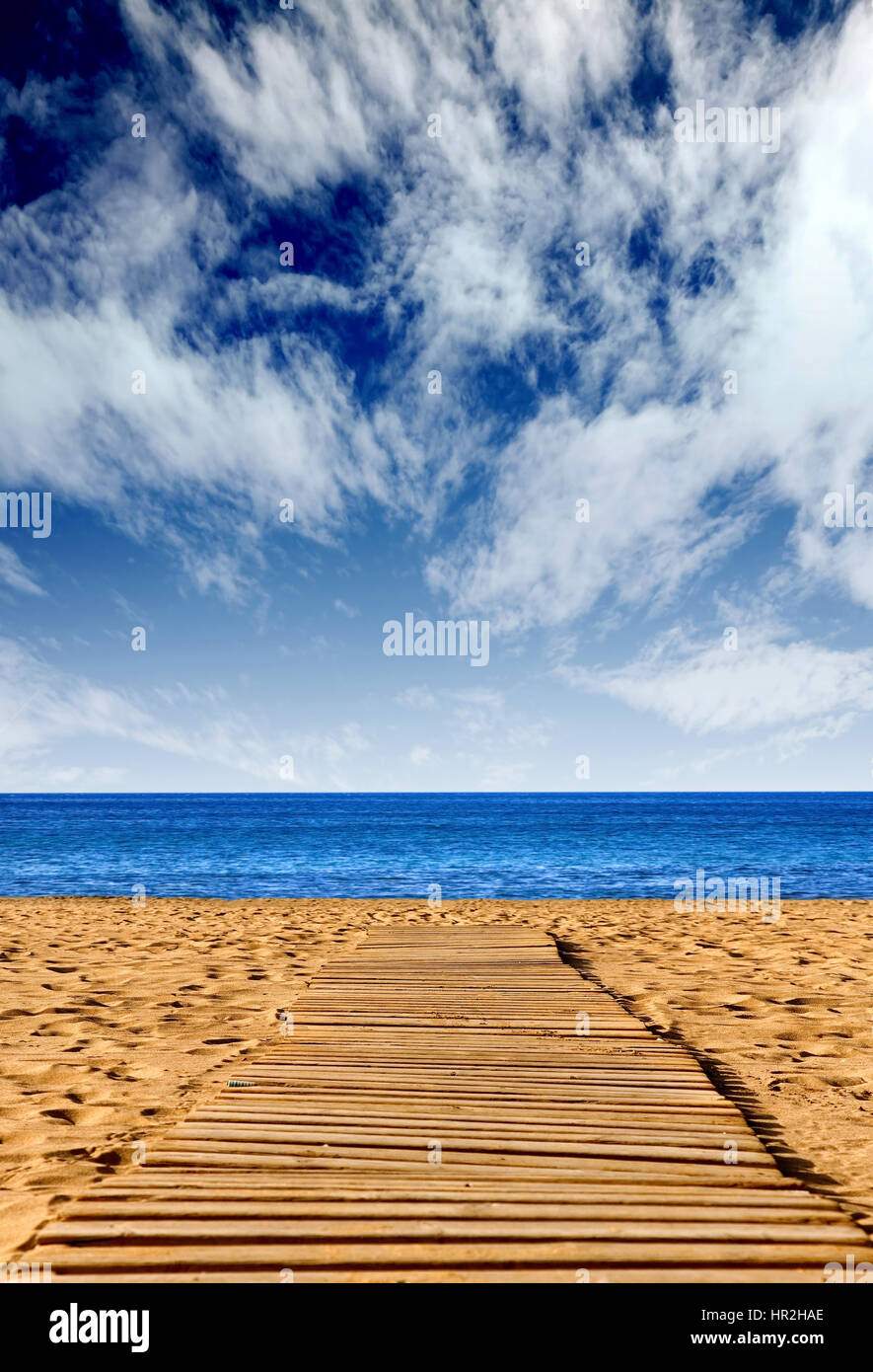 beach scene with a wooden path leading to the sea Stock Photo - Alamy