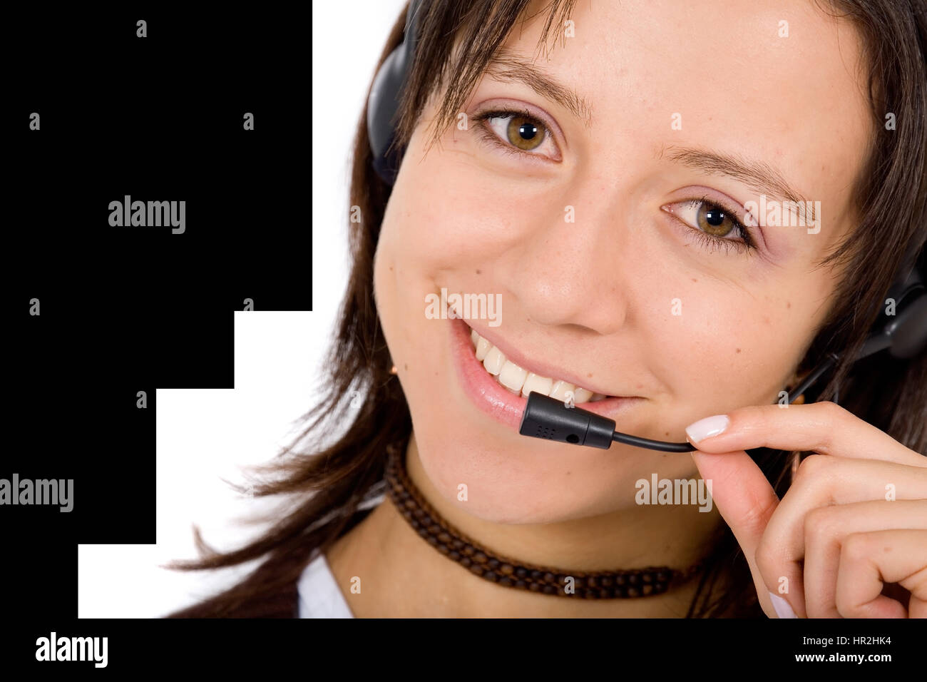 customer service girl smiling with hand on headset - isolated over a ...