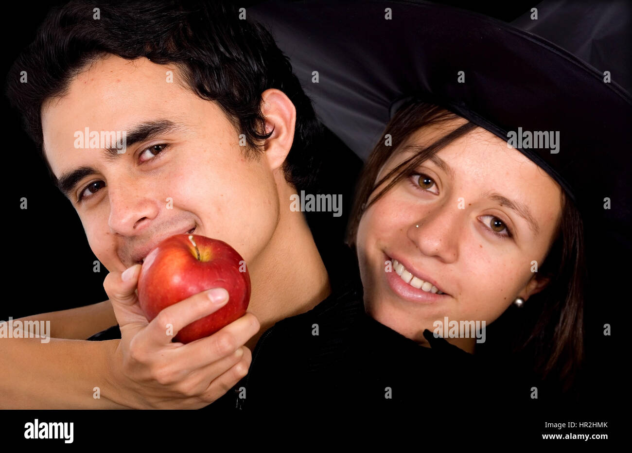 girl in a couple holding the apple of temptation for the man - isolated ...