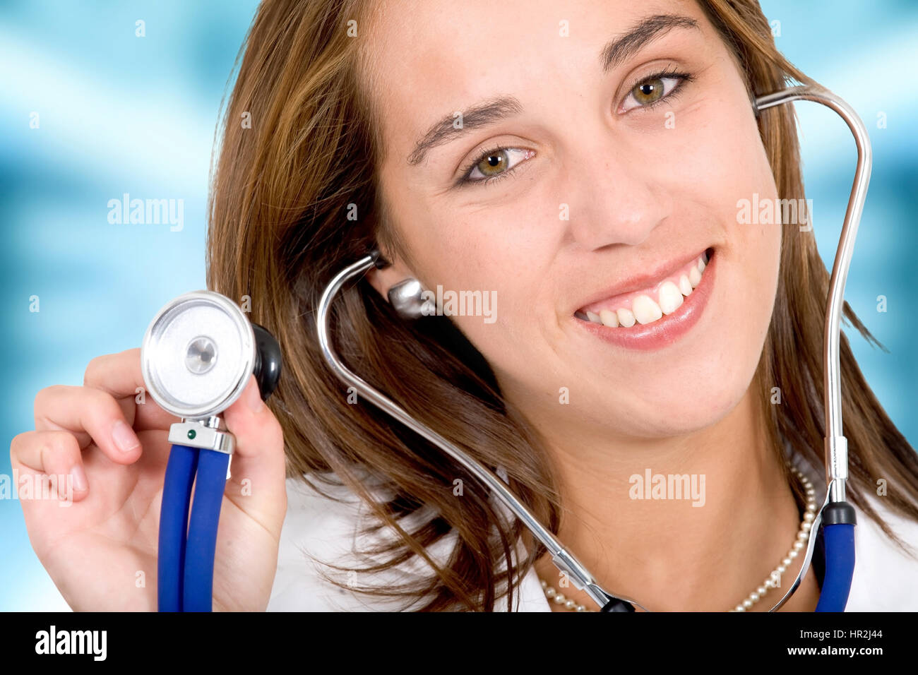 beautiful female doctor portrait in a hospital over a blue background ...