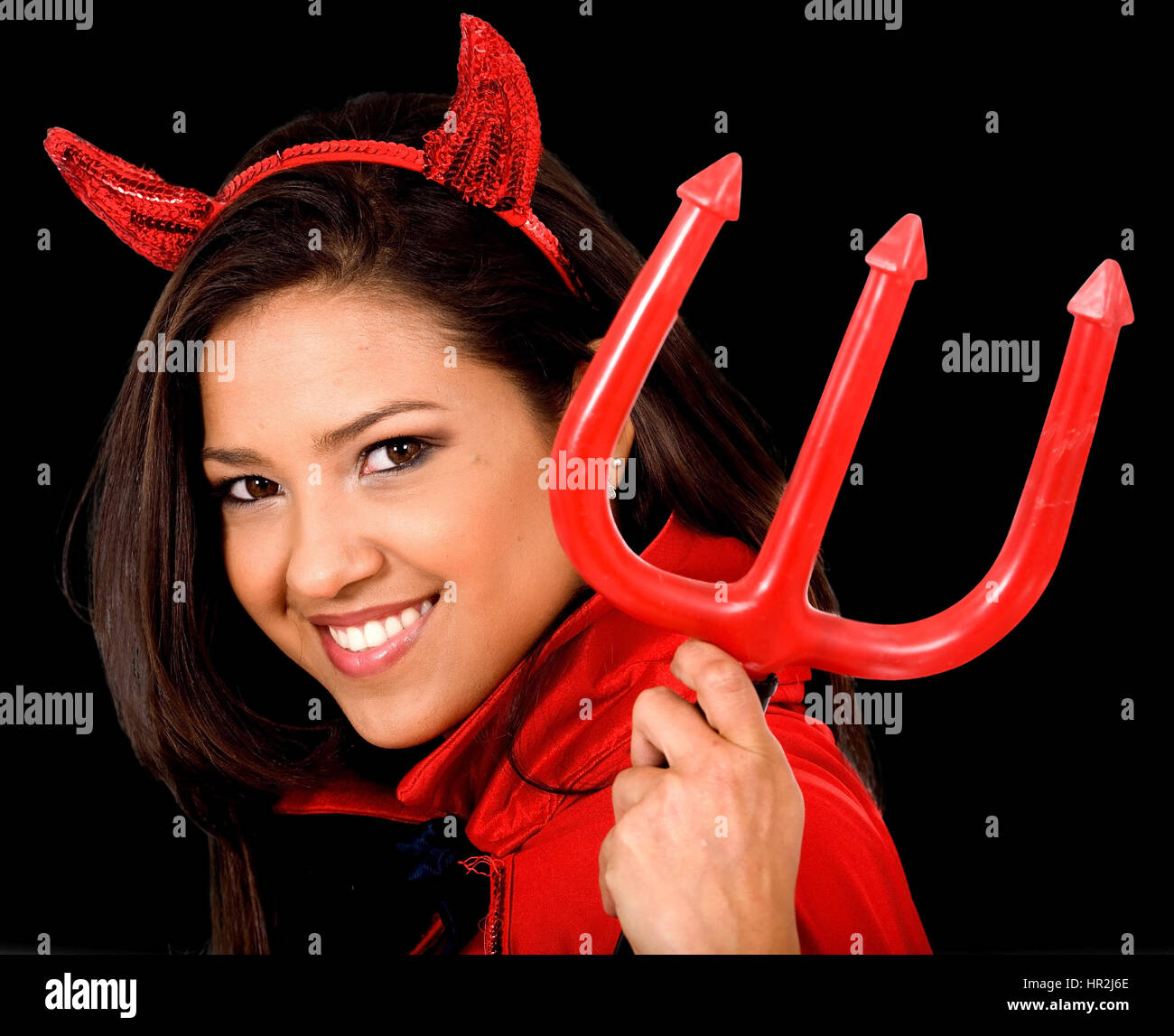 beautiful female devil in red over a dark background Stock Photo - Alamy