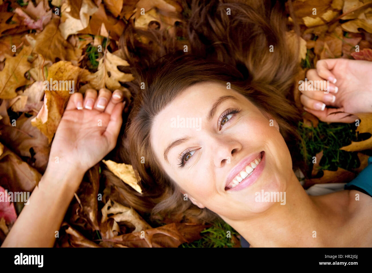 autumn girl portrait smiling and relaxing on the floor Stock Photo - Alamy