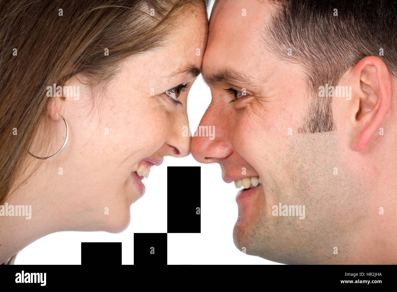 couple captured in a happy moment smiling and facing each other ...