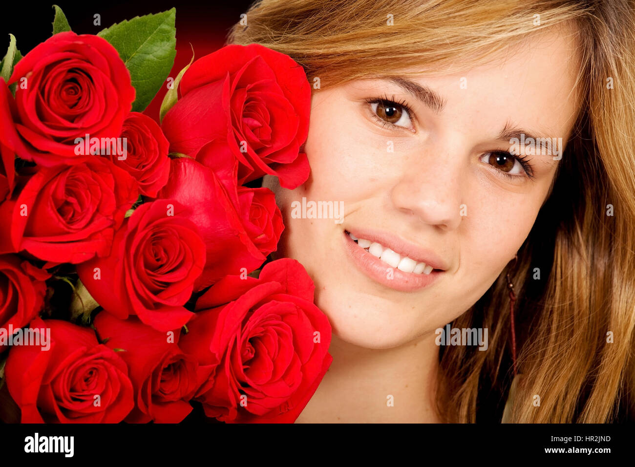 beautiful girl portrait with red roses over a dark background Stock ...