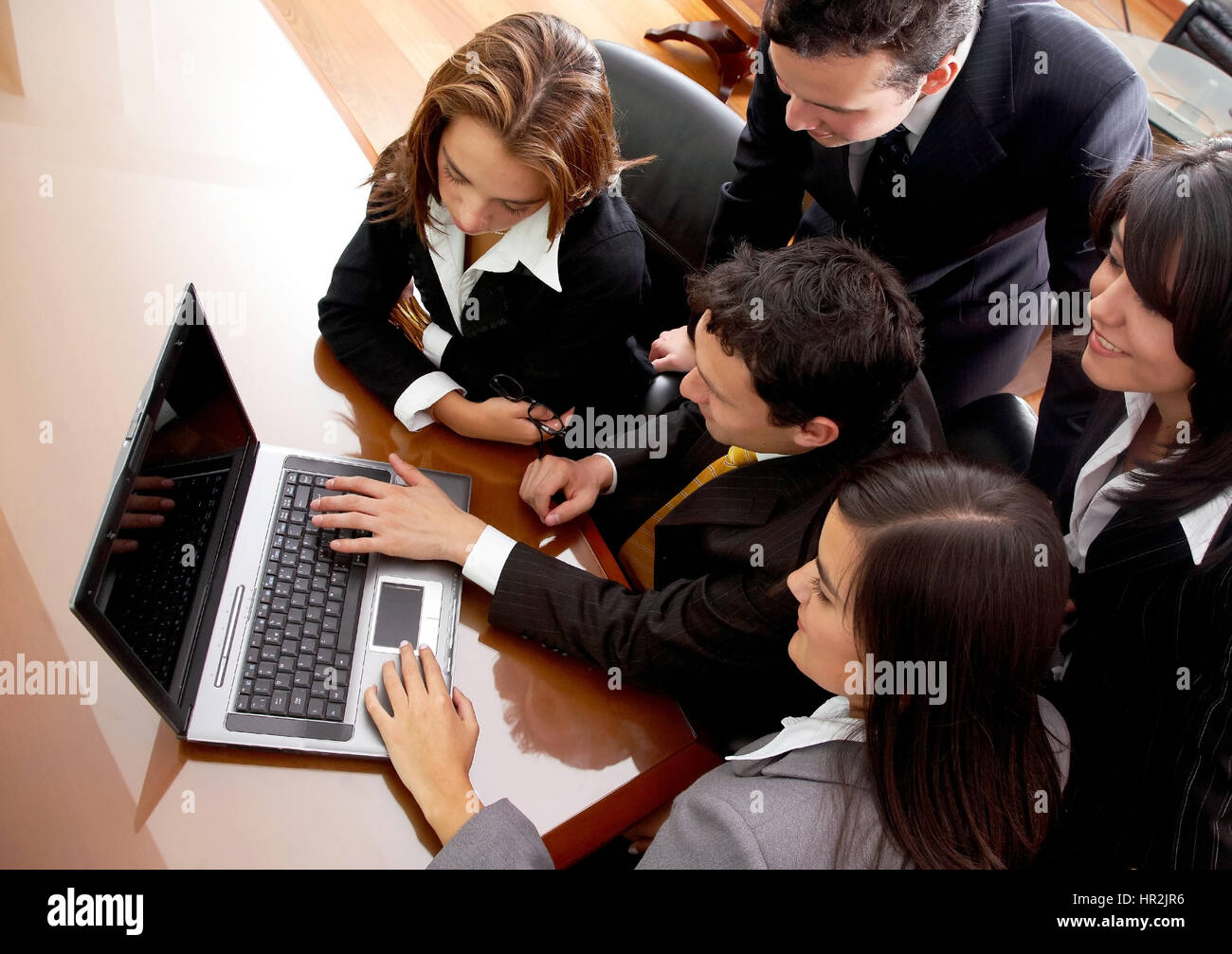 business team in an office laptop computer smiling Stock Photo - Alamy