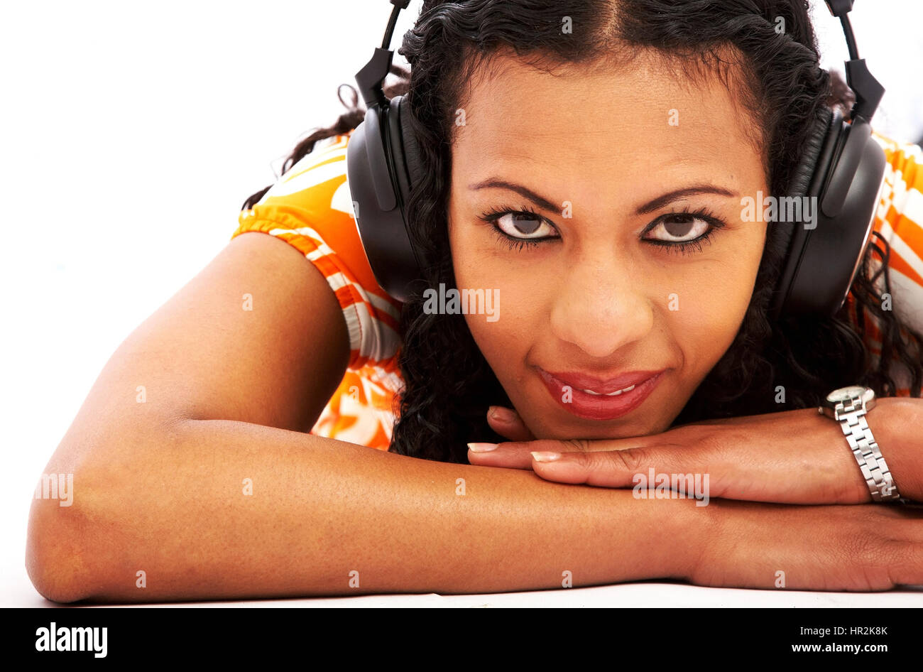black girl listening to music looking happy over white Stock Photo - Alamy