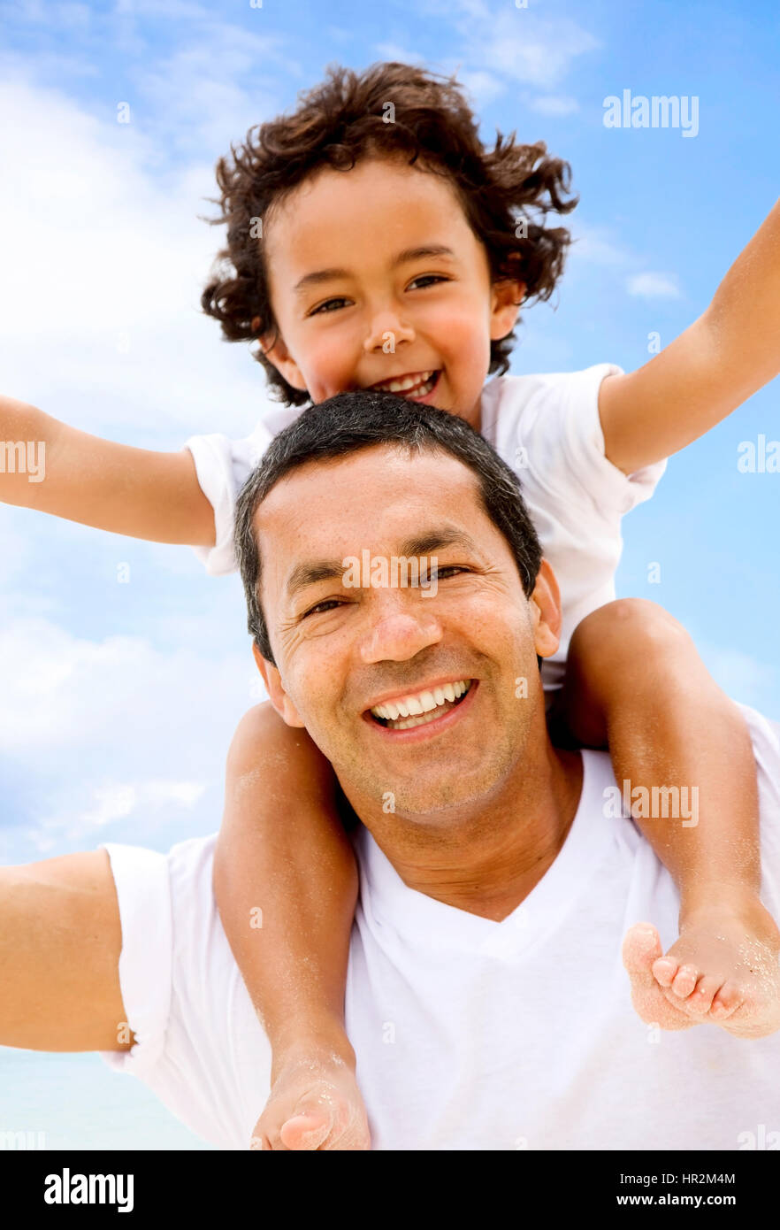 family lifestyle portrait of a dad with his son having fun outdoors ...
