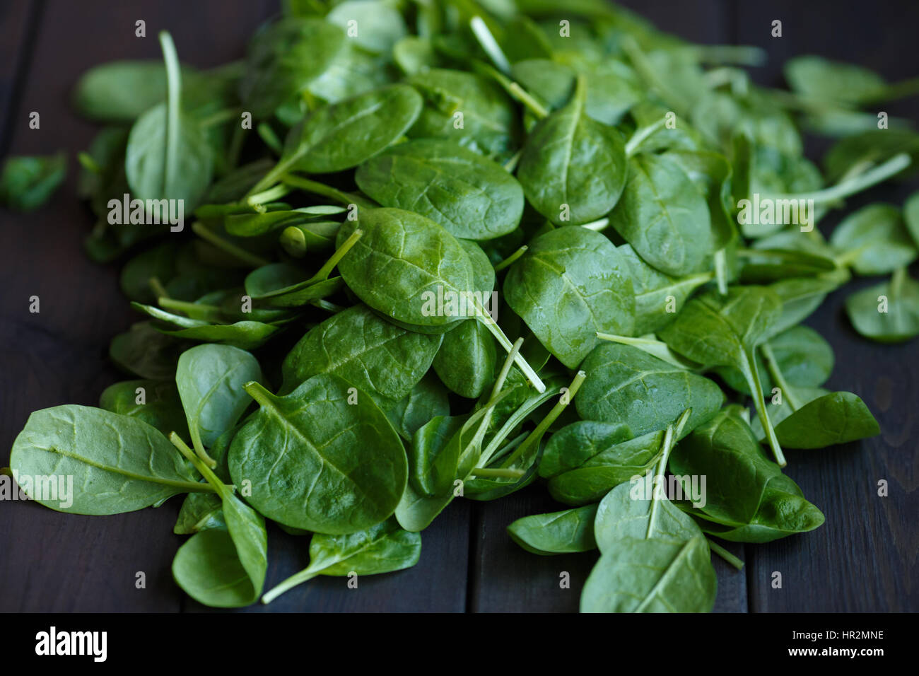 Fresh green spinach on the dark wood background Stock Photo - Alamy