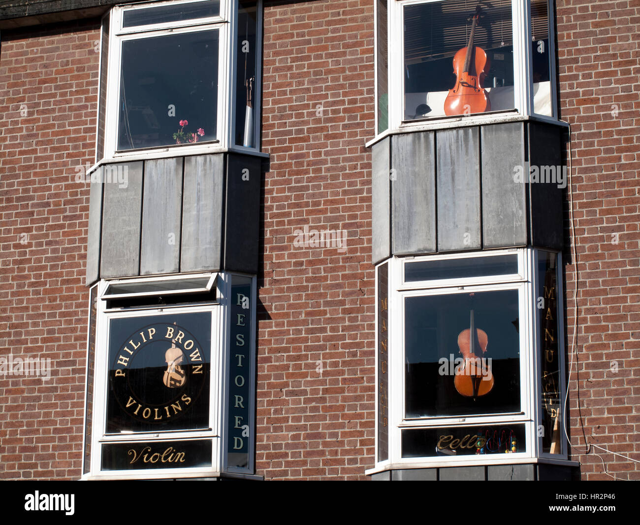 Phillip Brown violins window display over retail units Stock Photo - Alamy