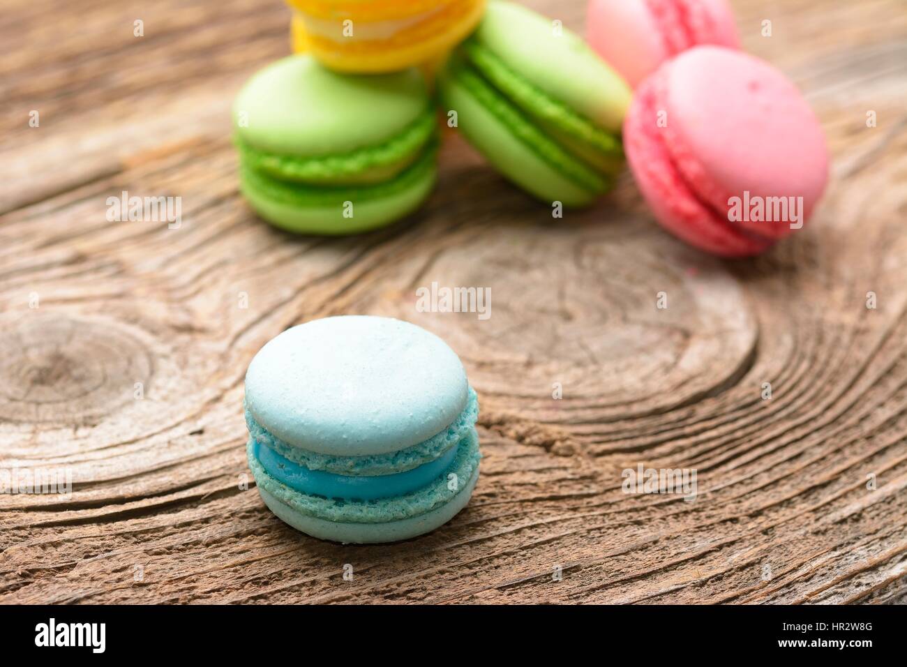 A lot of french colorful macarons on a woody floor Stock Photo - Alamy