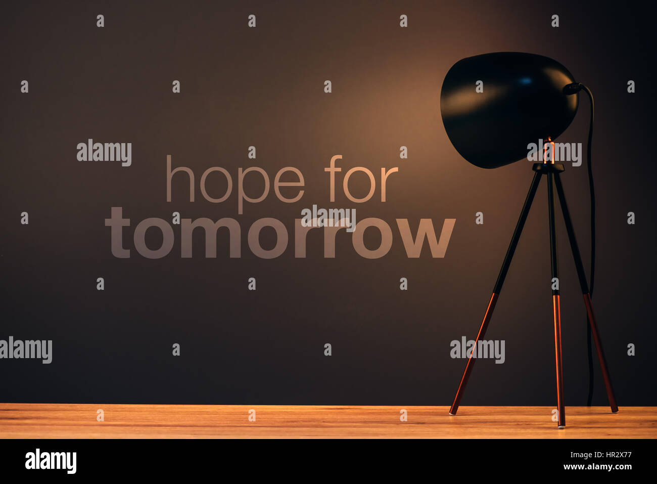Hope for tomorrow, motivational quote on office wall illuminated with ...