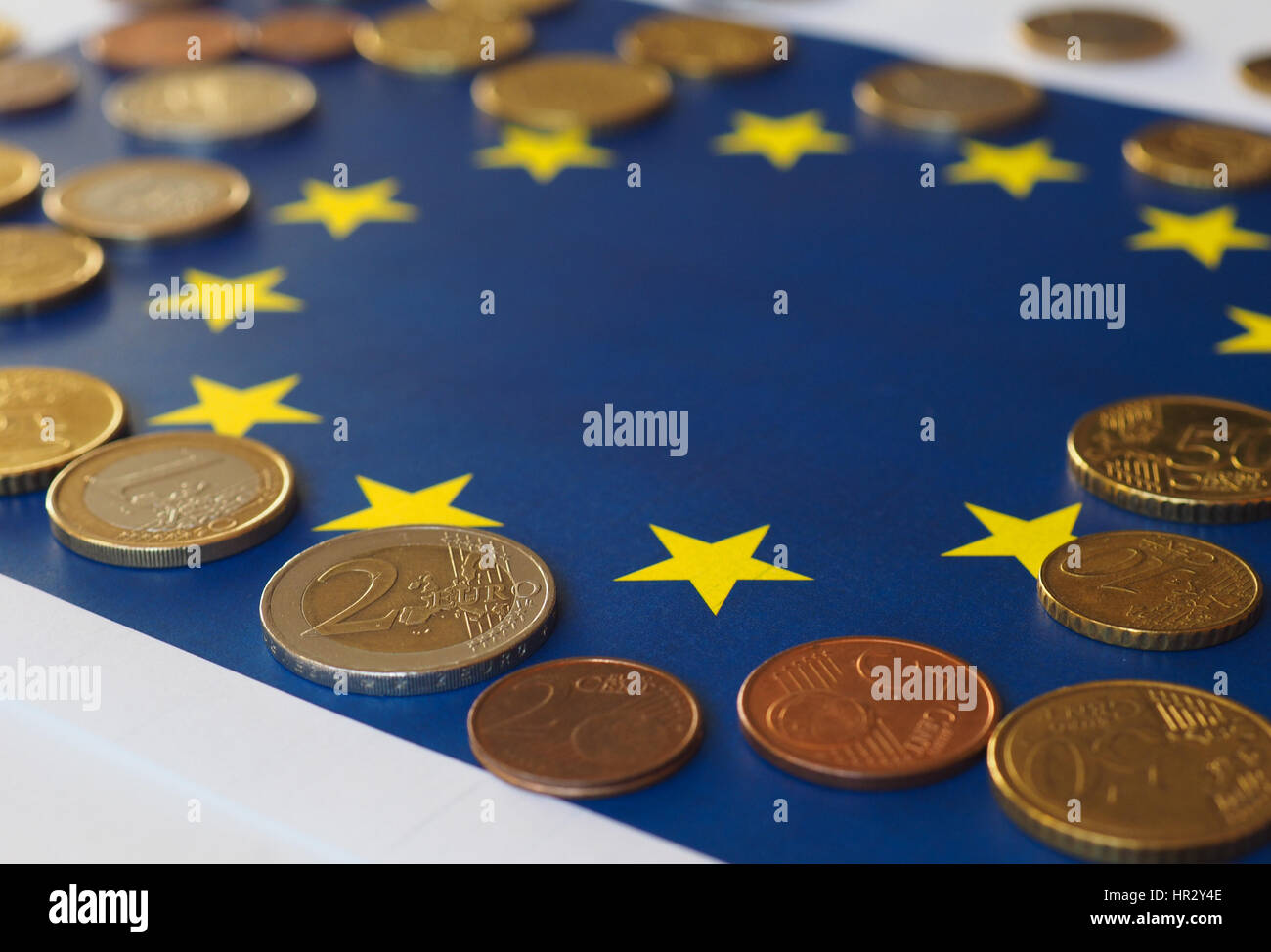 Euro coins (EUR), currency of European Union over flag of Europe Stock ...