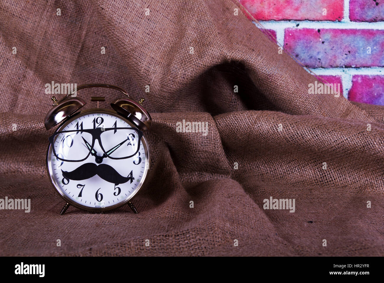 Alarm clock with a comedy black hipster mustache Stock Photo - Alamy