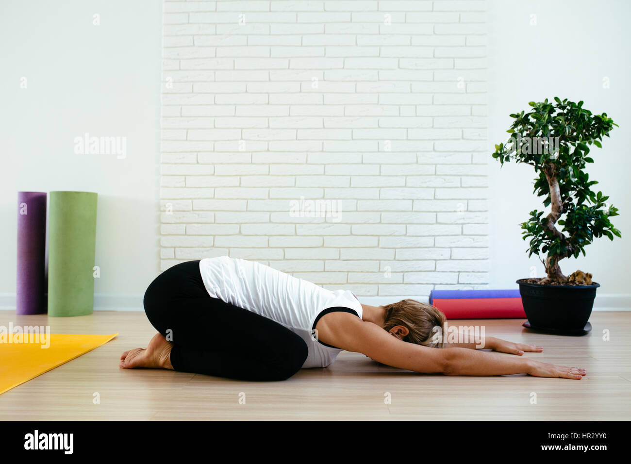 woman doing childs pose in yoga class. soft focus on hand Stock Photo ...