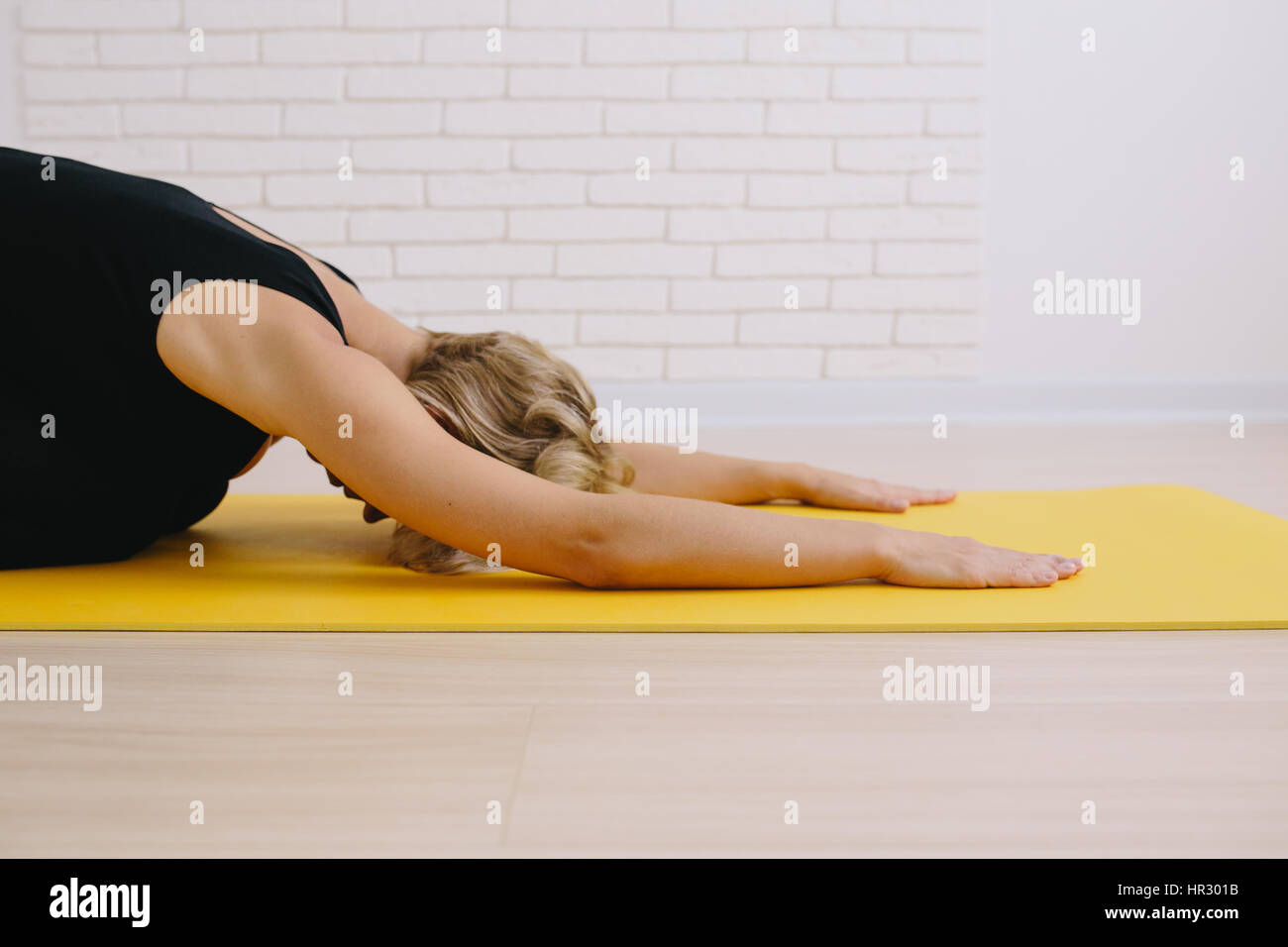 woman doing childs pose in yoga class. soft focus on hand Stock Photo ...