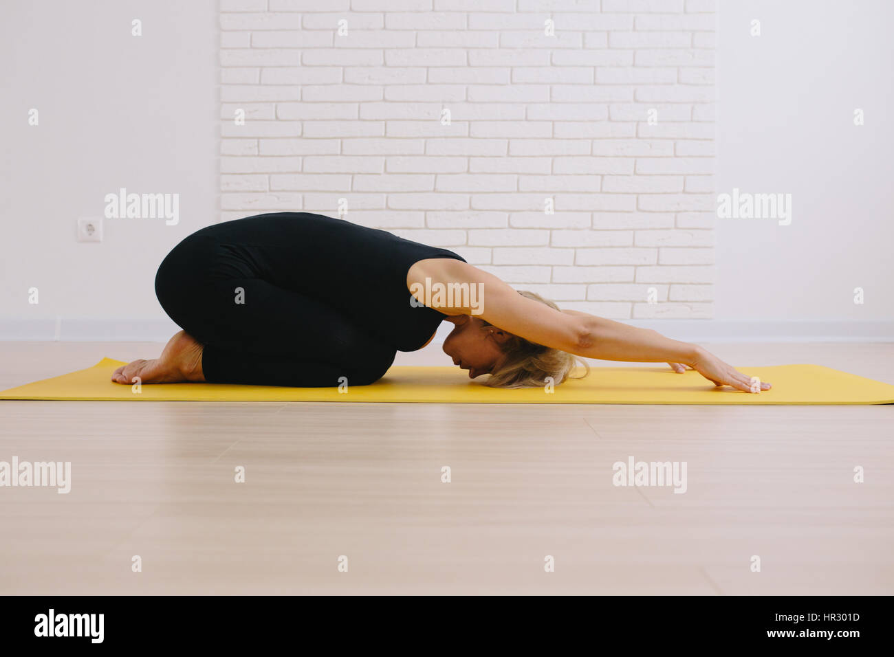 woman doing childs pose in yoga class. soft focus on hand Stock Photo ...