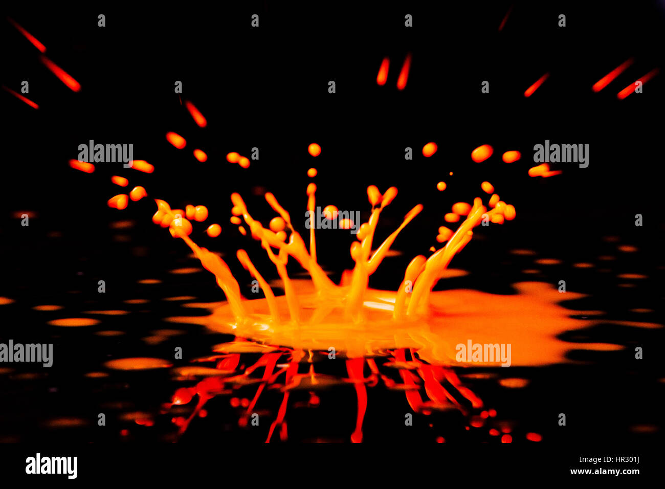 Colorful paint drop splashing on black a background Stock Photo - Alamy