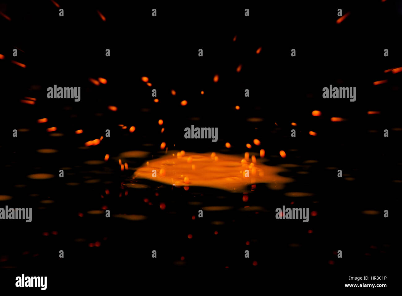 Colorful paint drop splashing on black a background Stock Photo - Alamy