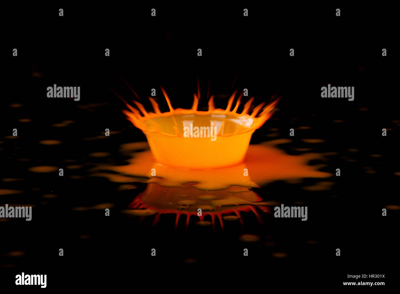 Colorful paint drop splashing on black a background Stock Photo - Alamy