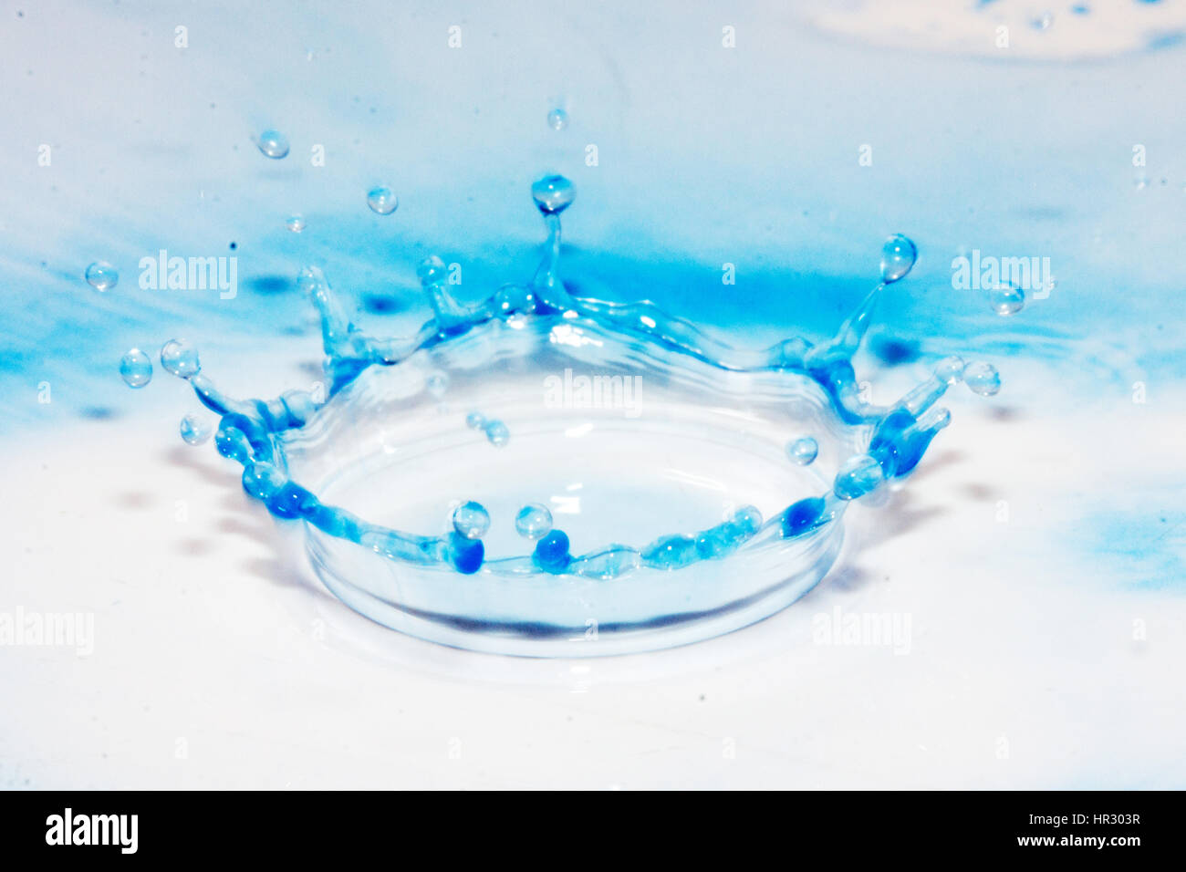 Colorful paint drop splashing on black a background Stock Photo - Alamy