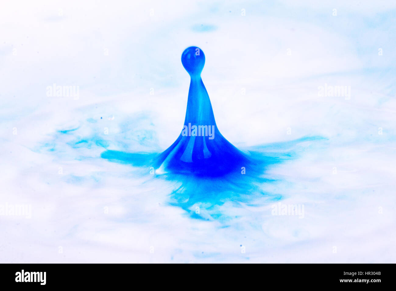 Colorful paint drop splashing on black a background Stock Photo - Alamy