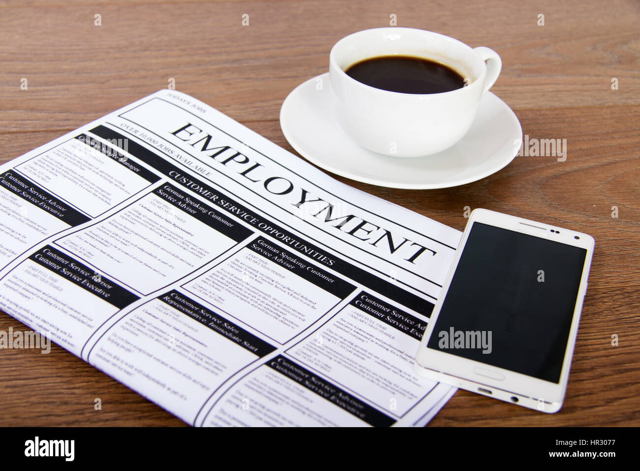 Searching for a new job or employment in a newspaper Stock Photo - Alamy