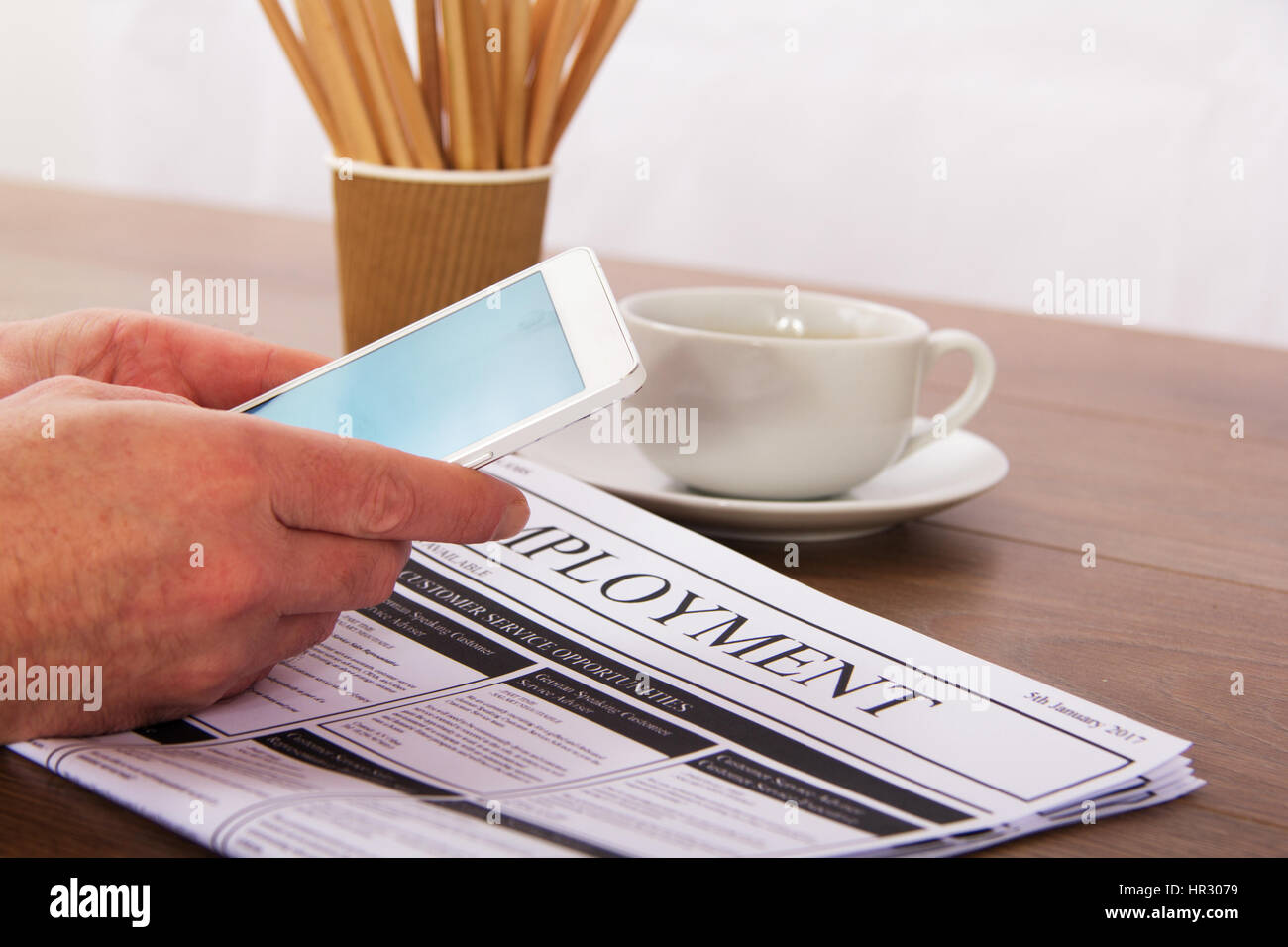 Searching for a new job or employment in a newspaper Stock Photo - Alamy