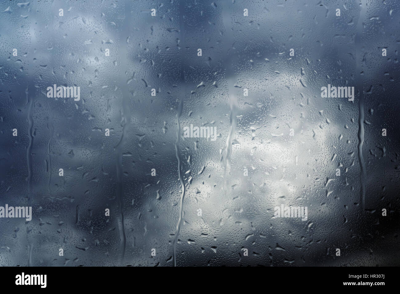 raindrops coming from very dark clouds on a window Stock Photo - Alamy