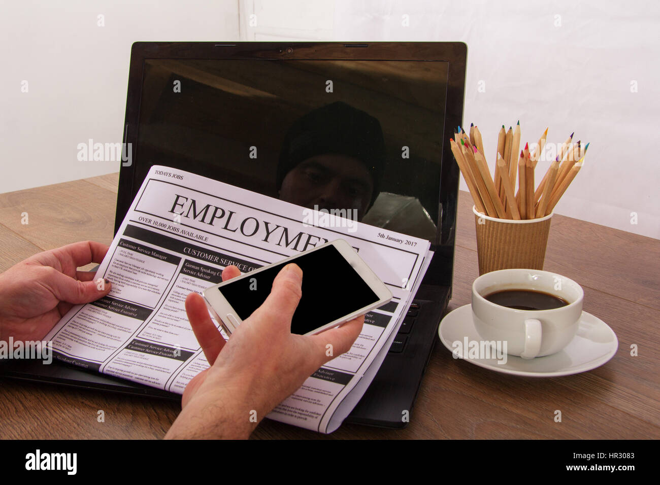 Searching for a new job or employment in a newspaper Stock Photo - Alamy