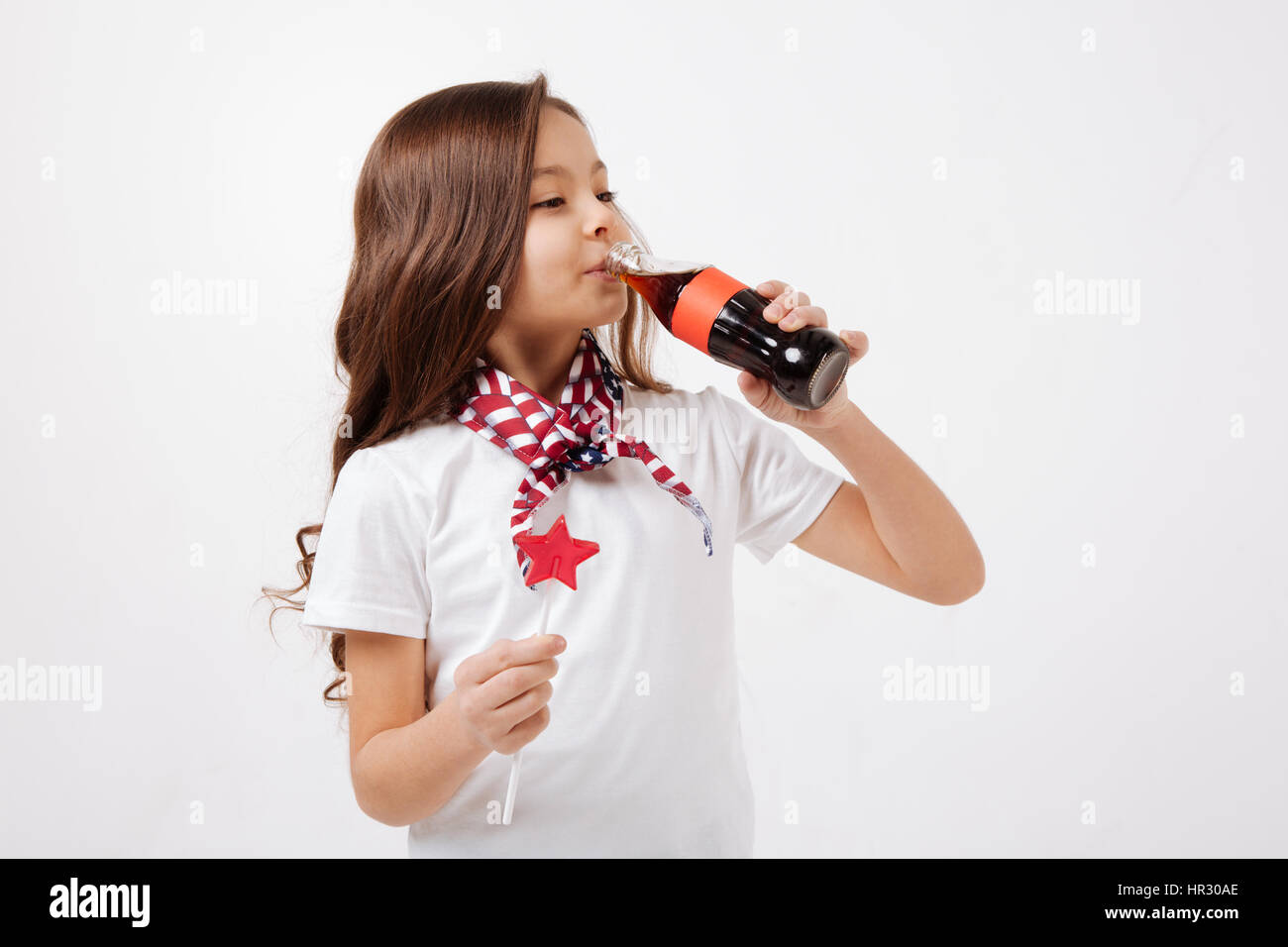 Tasting new nonalcoholic beverage. Cheerful amused lively girl ...