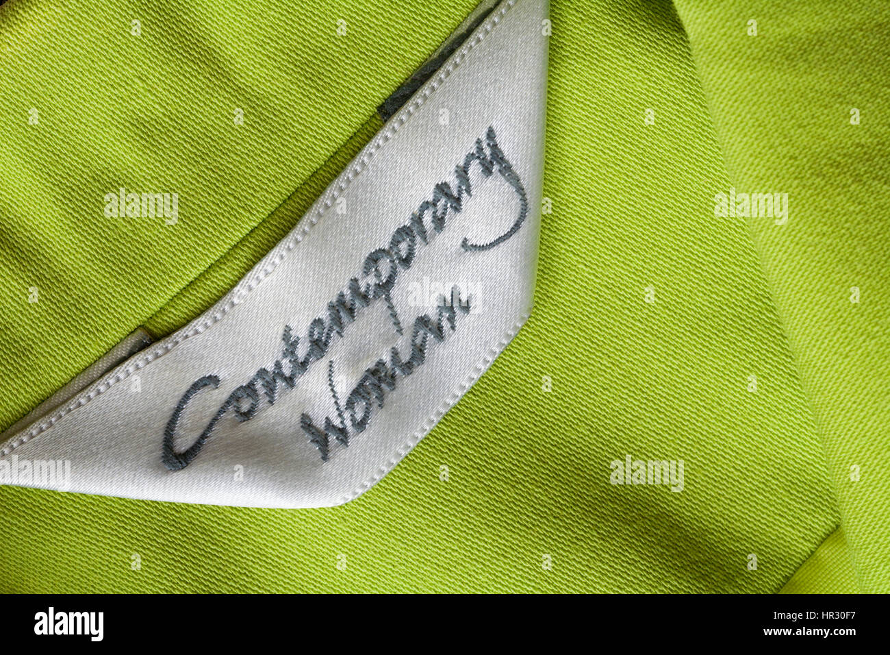 Contemporary Woman label in woman's green jacket close up Stock Photo ...