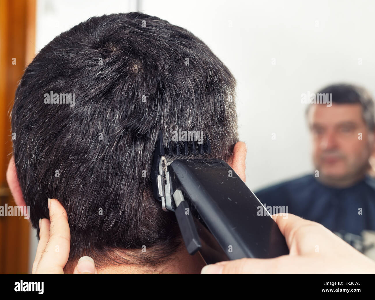 barber making haircut to man Stock Photo - Alamy