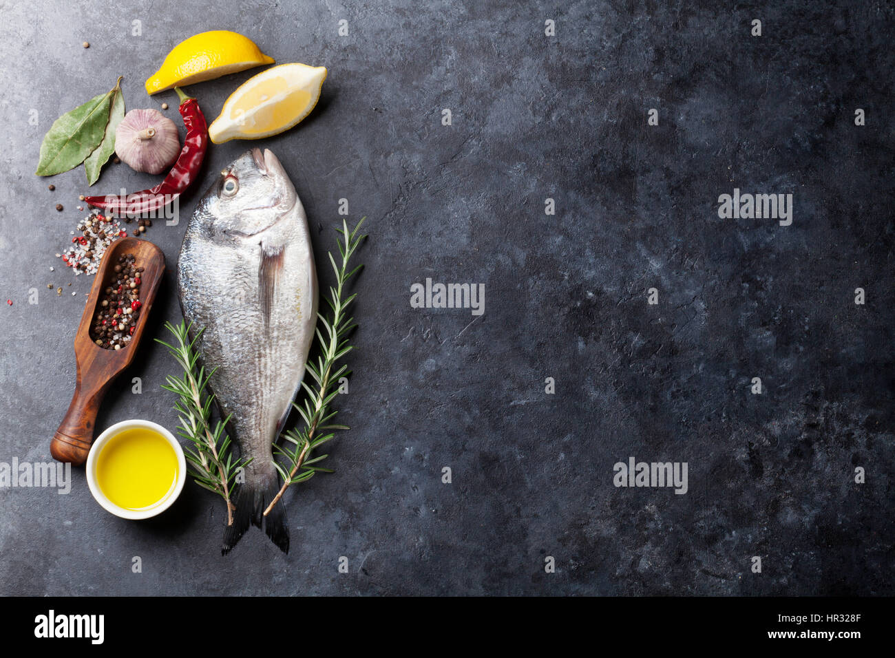 Raw fish cooking and ingredients. Dorado, lemon, herbs and spices. Top ...