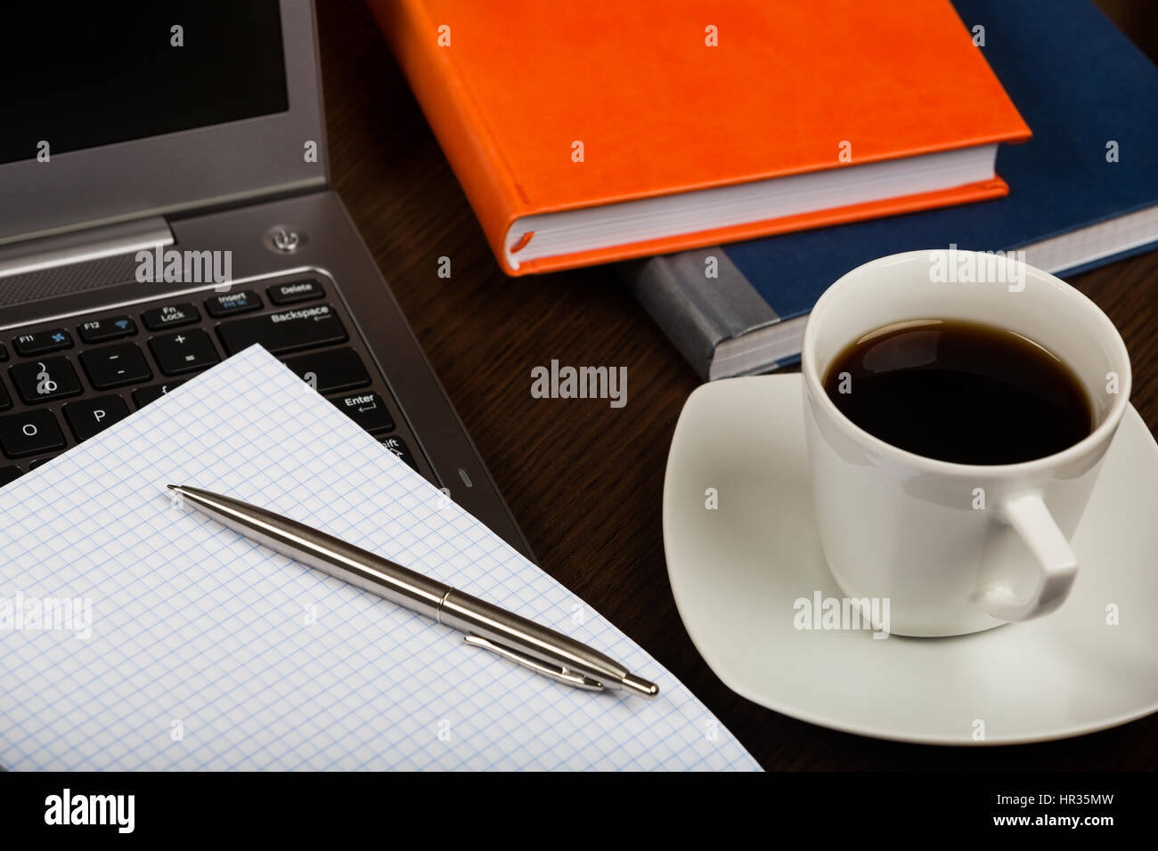 Laptop, cup of coffee, books, pen, sheet of paper and cup of coffee on ...