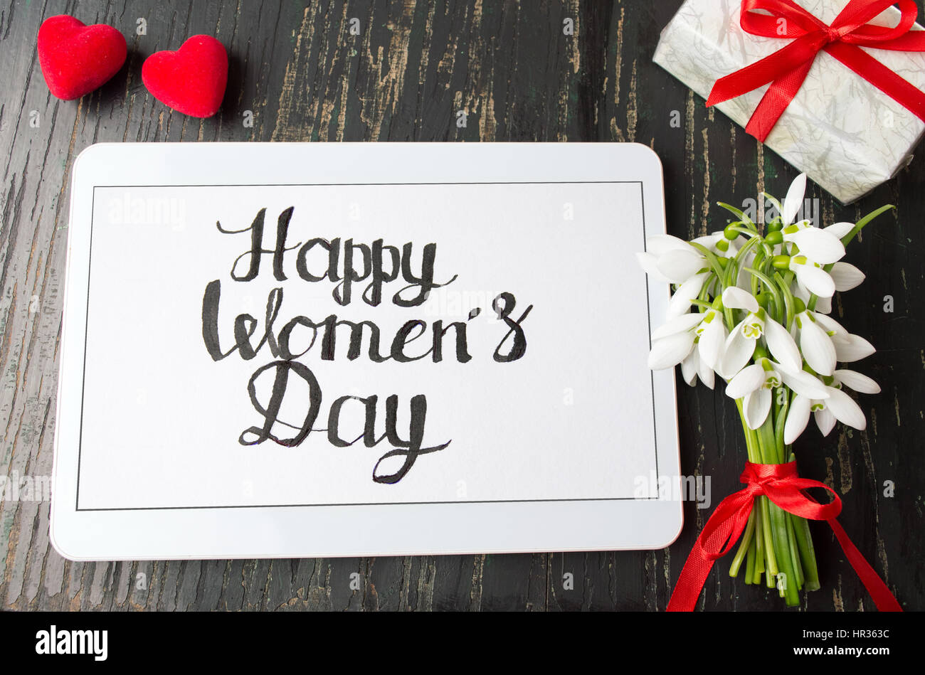 Happy womens day calligraphy note on a white tablet Stock Photo - Alamy