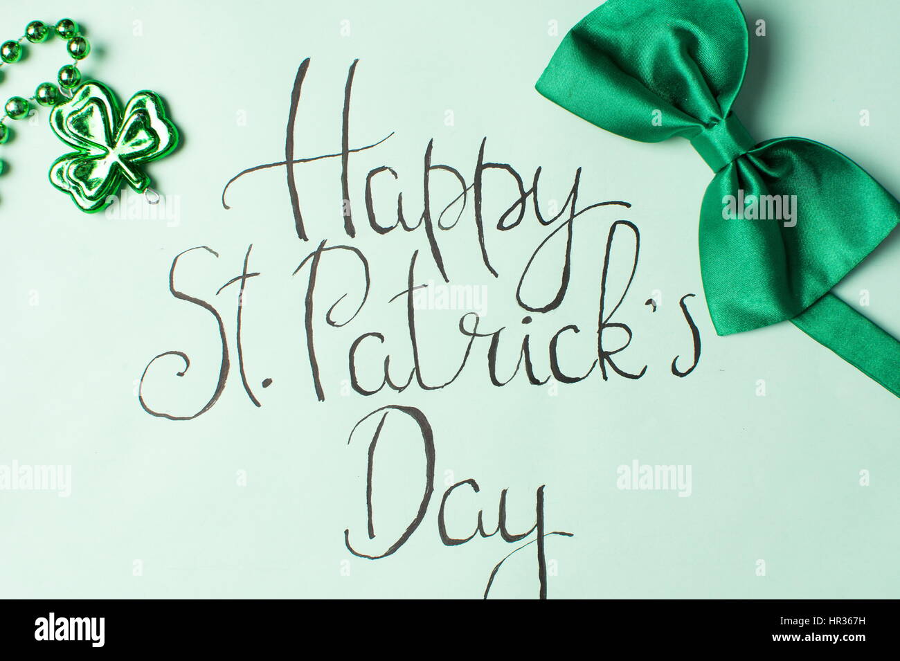 Happy St Patrick day calligraphy card and green accessories Stock Photo ...