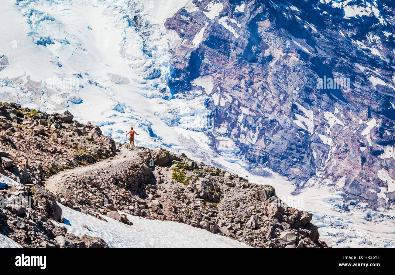 A woman hiking on First Burroughs Mountain below Mount Rainier ...