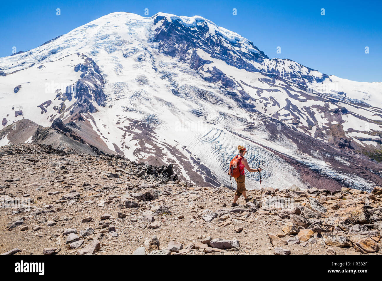 A woman near top summit of Burroughs Mountain with Mount Rainier ...