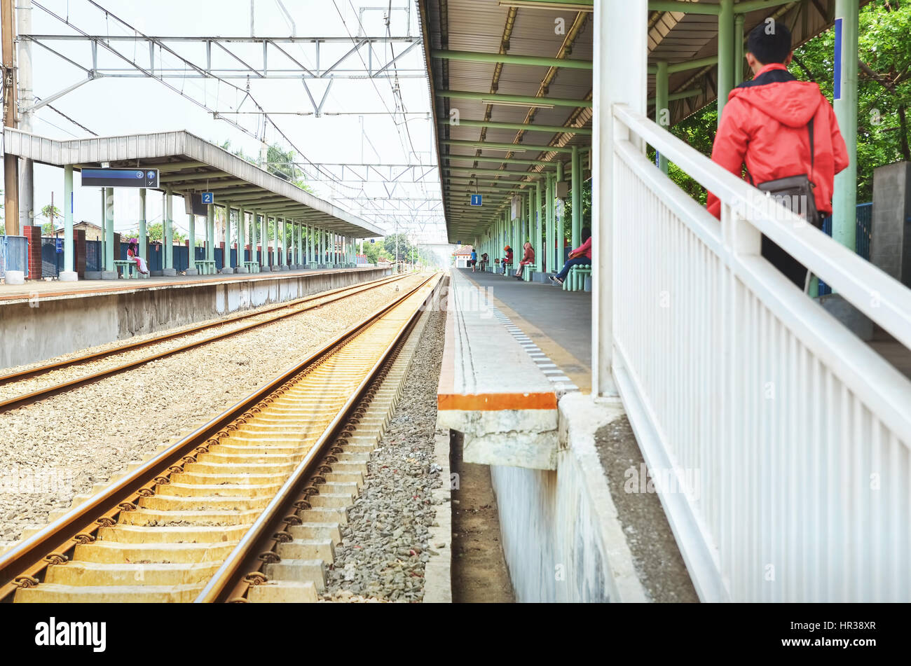 Concrete platform and railway in train station Stock Photo - Alamy