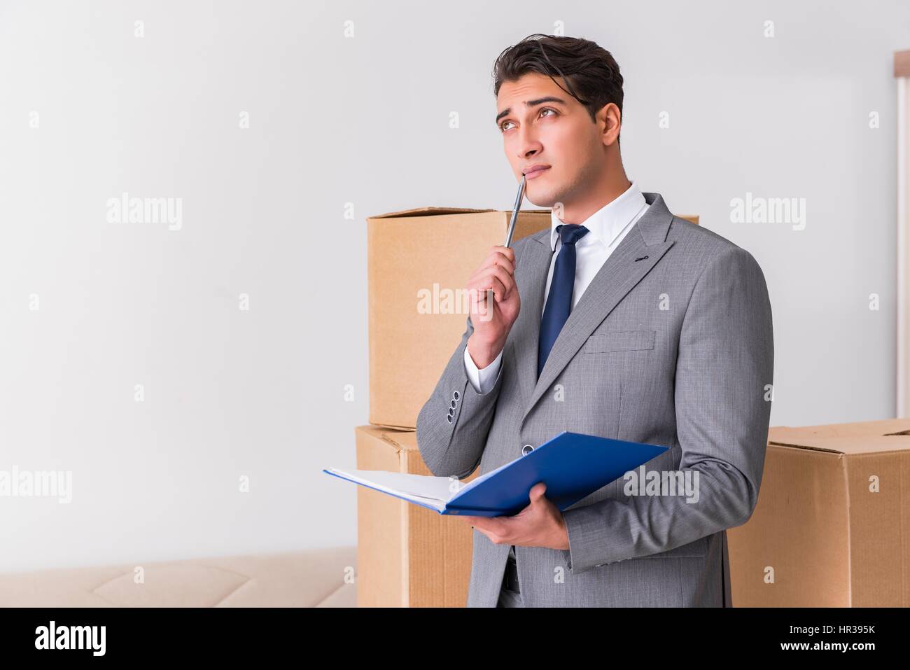 Man signing for the delivery of boxes Stock Photo - Alamy