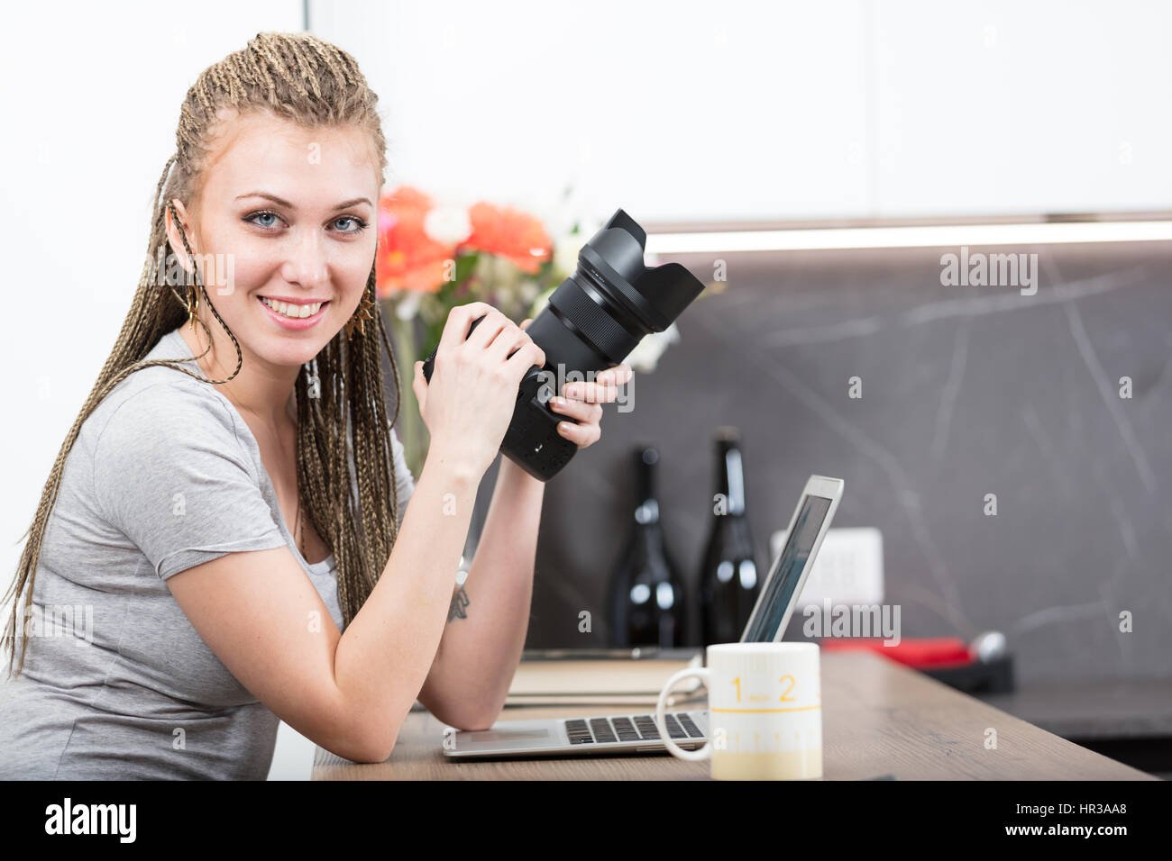 passionate woman is a photographer in her kitchen, with her faithful ...