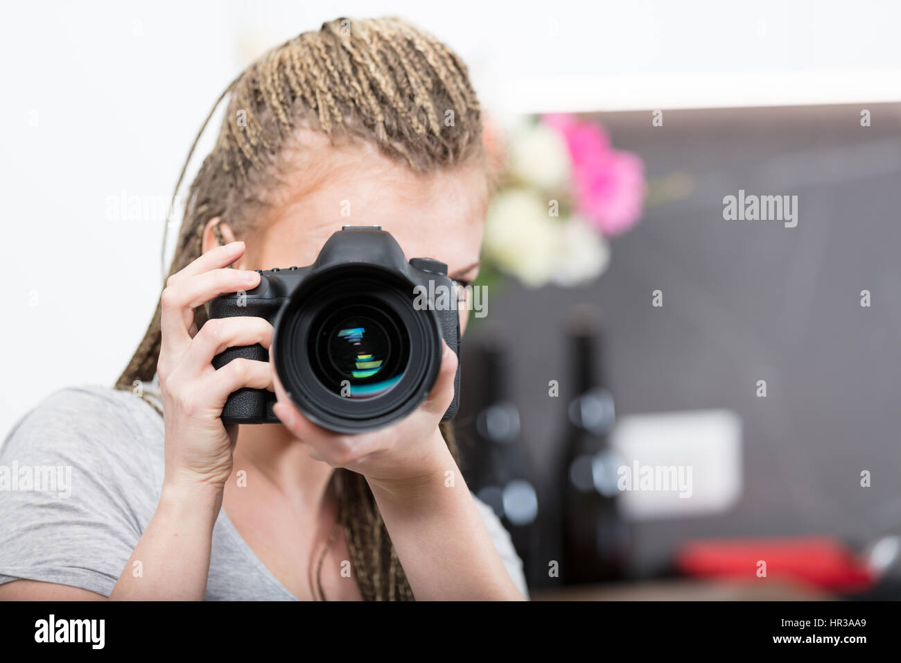 passionate woman is a photographer in her kitchen, with her faithful ...