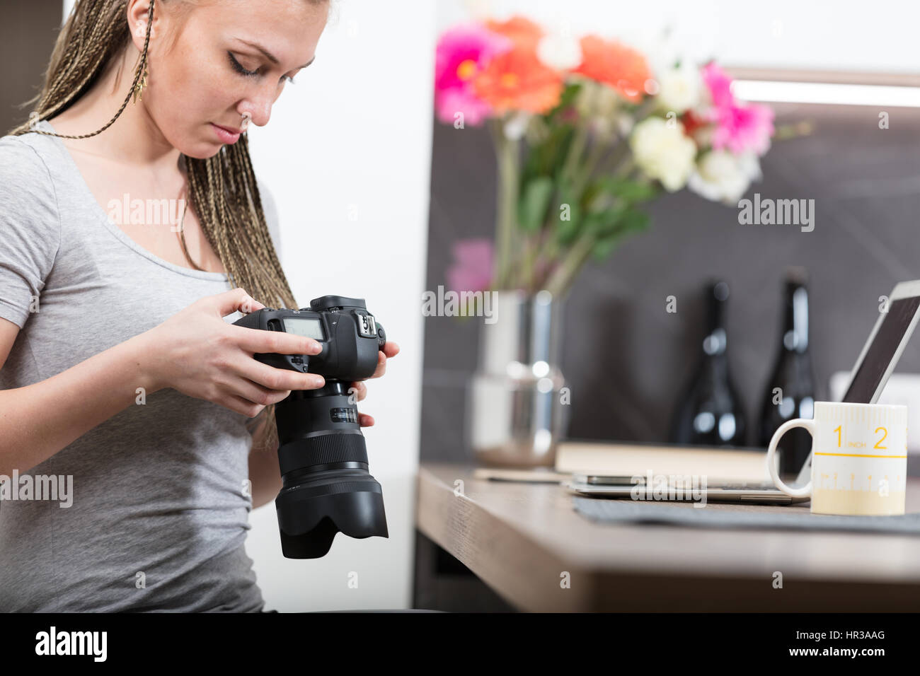 passionate woman is a photographer in her kitchen, with her faithful ...