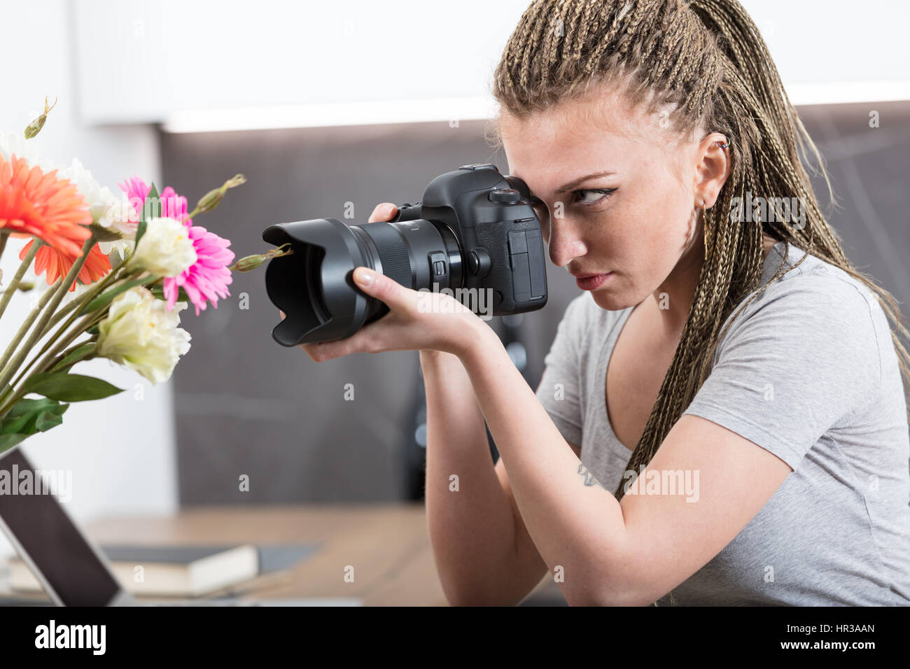 passionate woman is a photographer in her kitchen, with her faithful ...