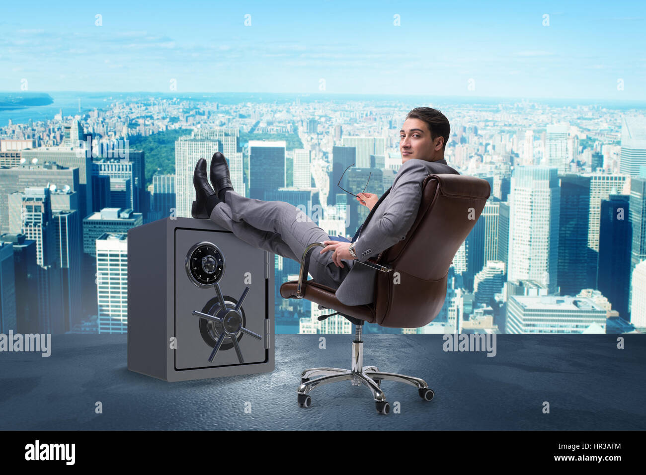 Businessman resting putting leg on safe Stock Photo - Alamy