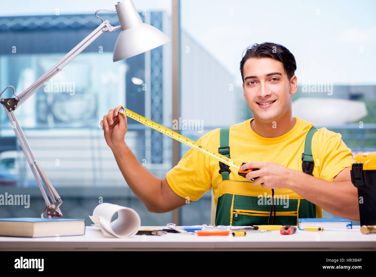 Construction worker sitting at the desk Stock Photo - Alamy