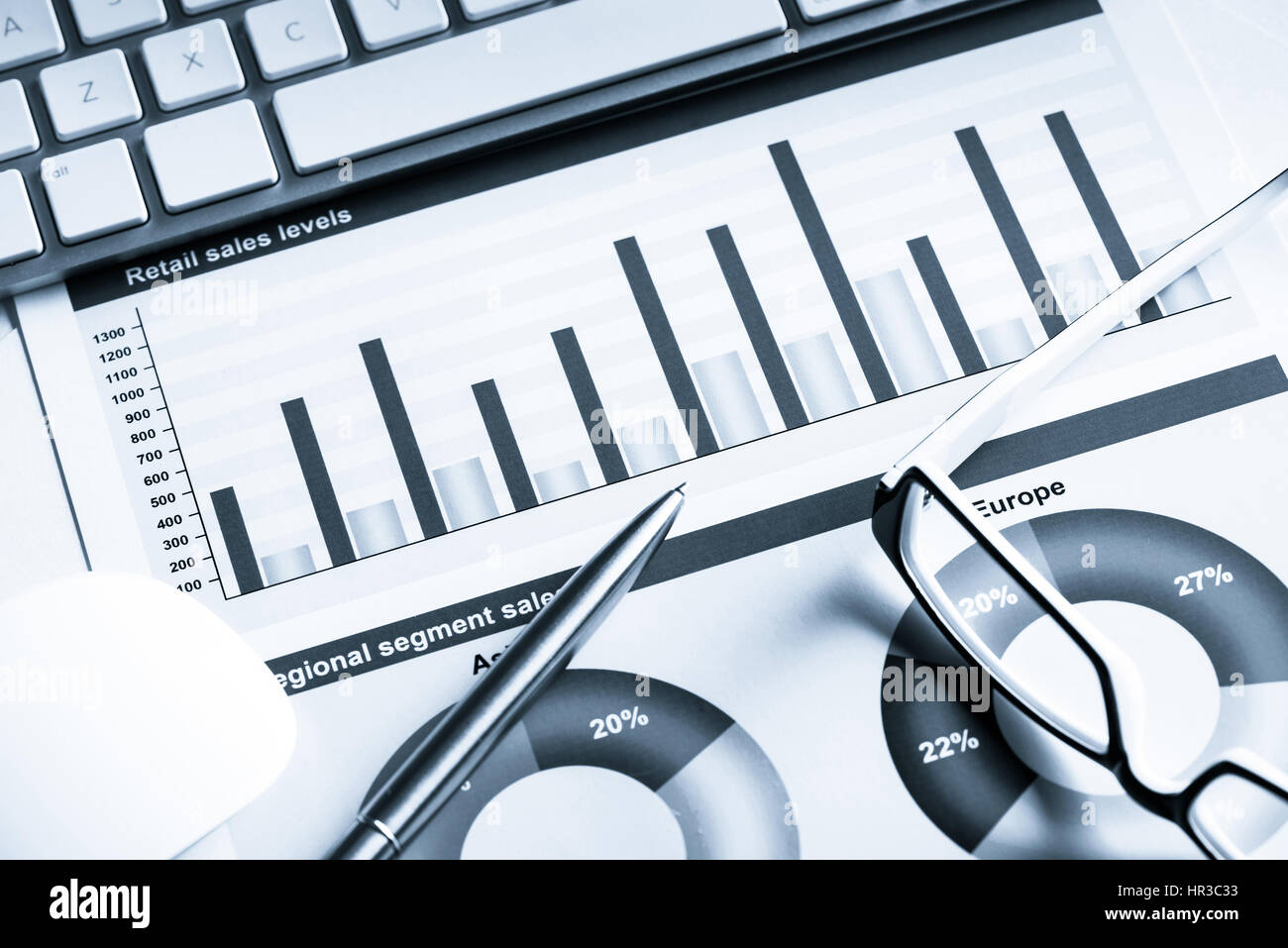 Business workplace with keyboard mouse and papers with graphs and ...