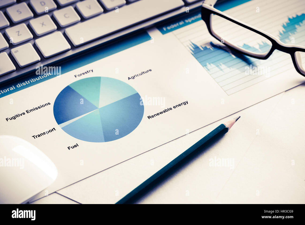Business workplace with keyboard mouse and papers with graphs and ...