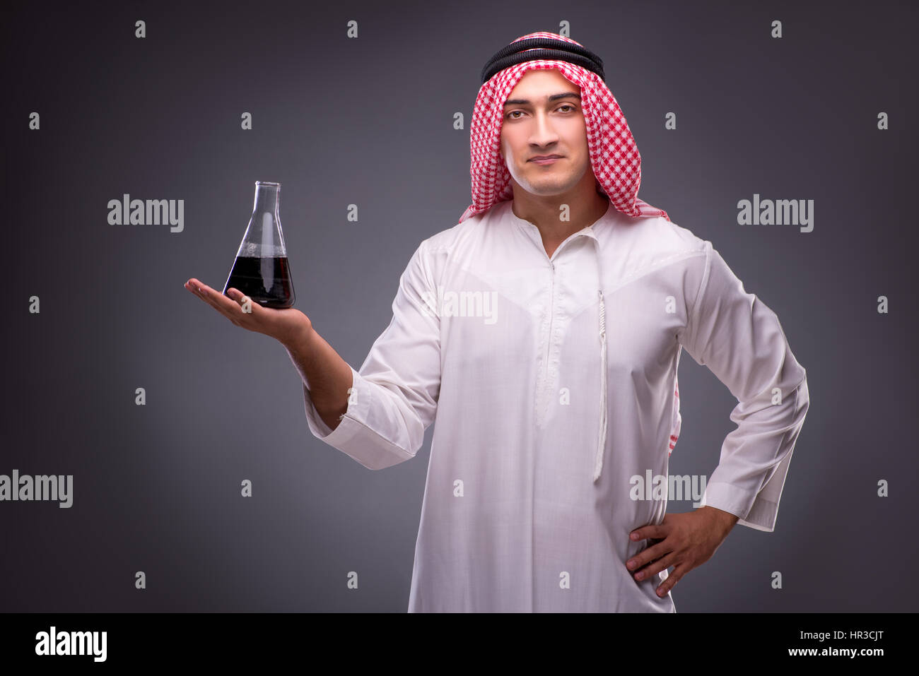 Arab with oil on gray background Stock Photo - Alamy
